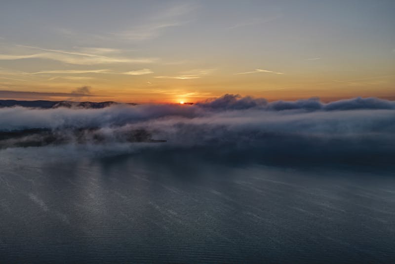 Golden sunset over Lake Maggiore with mountains silhouetted in the background