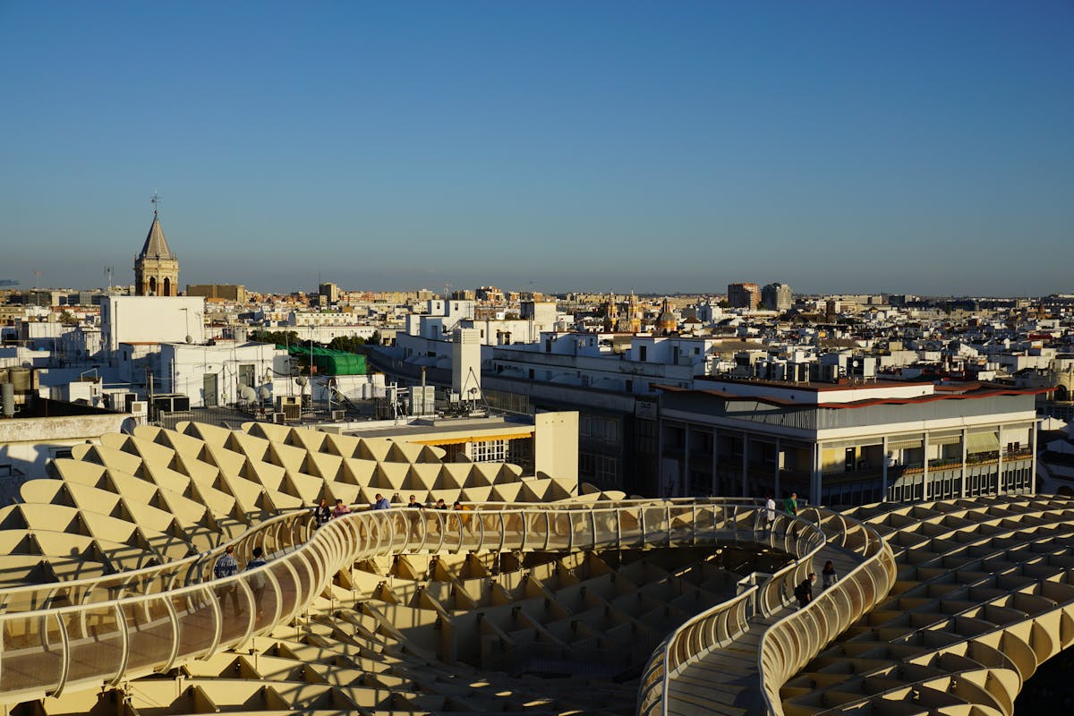 View of Metropol Parasol structure against the Seville cityscape under blue sky