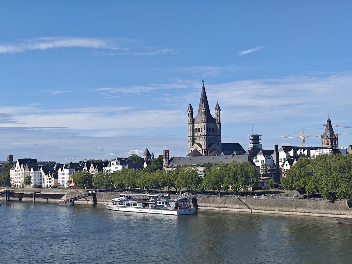 Cologne riverside with Great St Martin Church and ship on Rhine