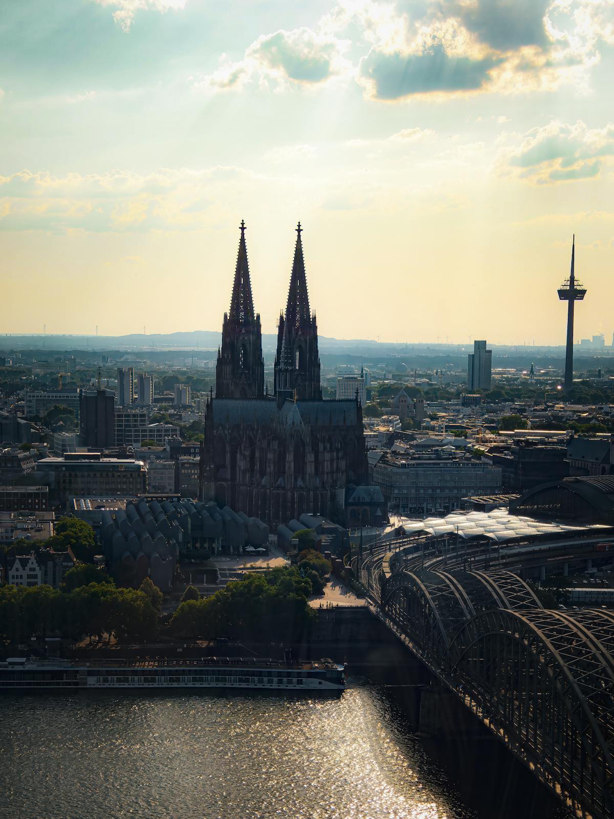 Aerial view of Cologne Cathedral and the Rhine River at sunset
