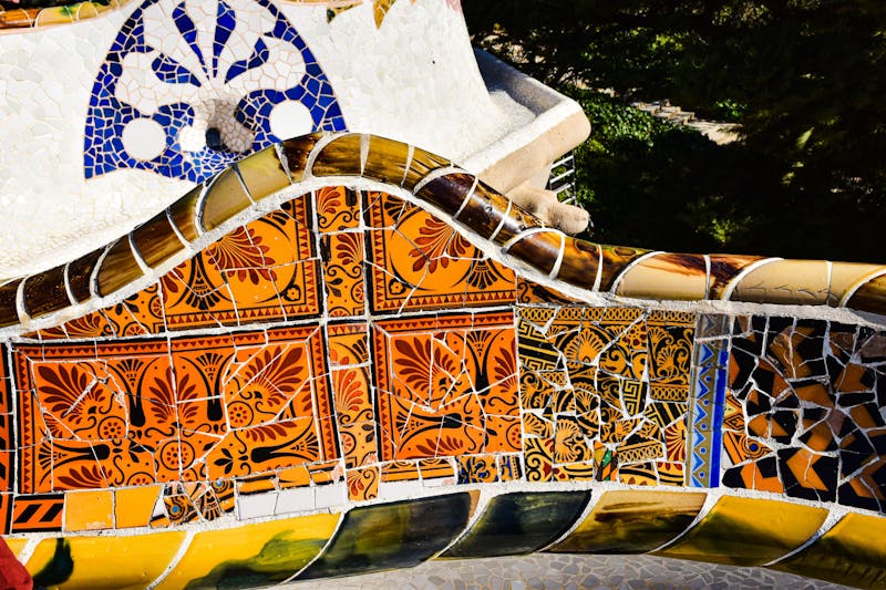 Close-up of colorful trencadis broken tile mosaic artwork at Park Guell