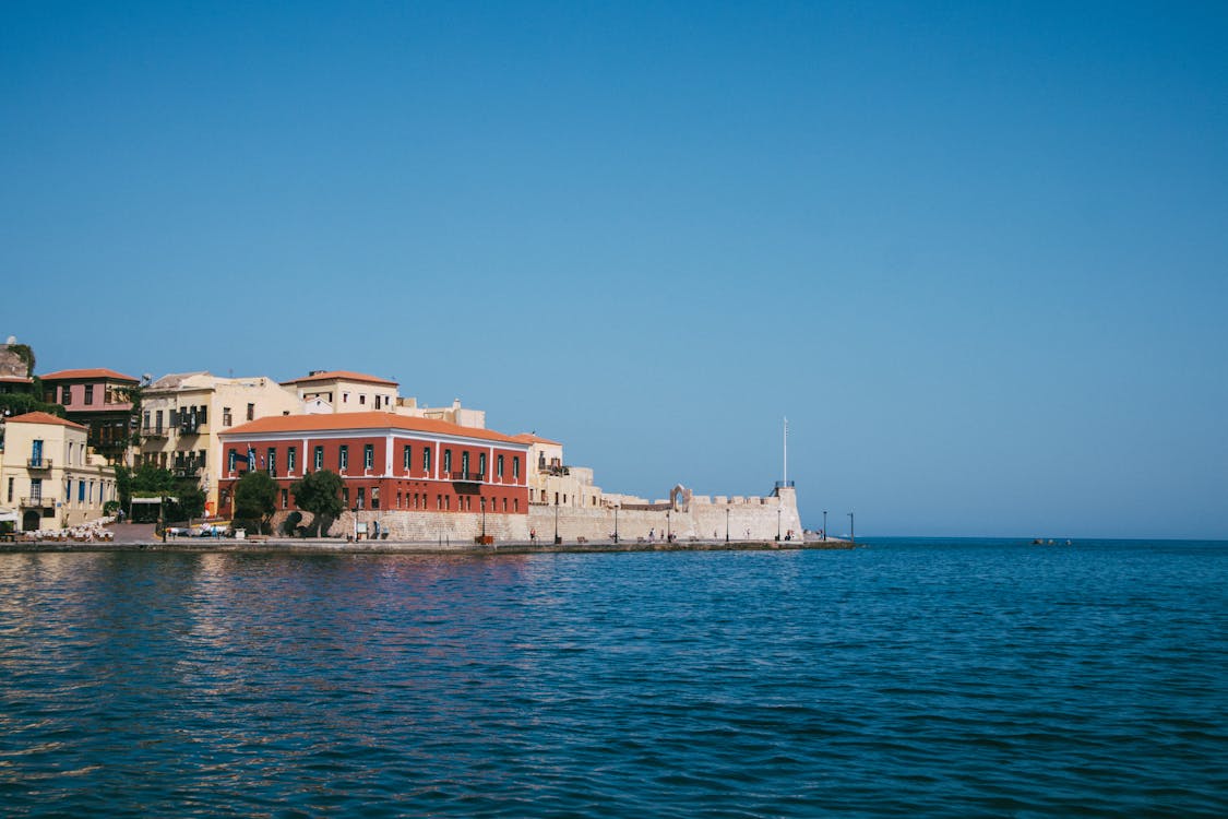 Picturesque waterfront view of Chania town in Crete, Greece with clear blue skies.