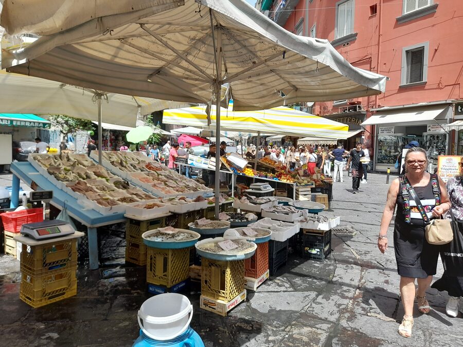 Pignasecca market in Naples with food stalls and vendors in narrow street