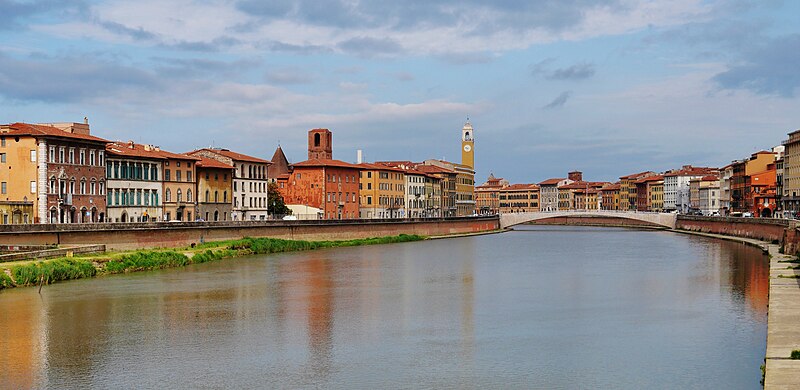 The Arno River flowing through Pisa lined with colorful historic buildings