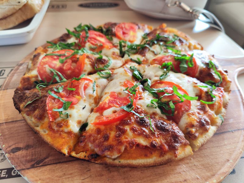 Close-up of a fresh Margherita pizza with tomatoes and basil