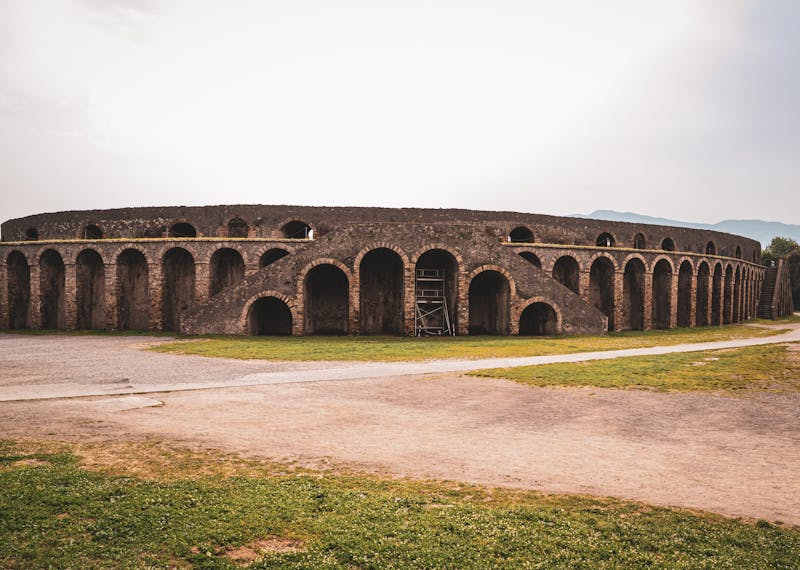 Stunning view of the well-preserved Roman amphitheater in Pompeii Italy showing stone seating tiers