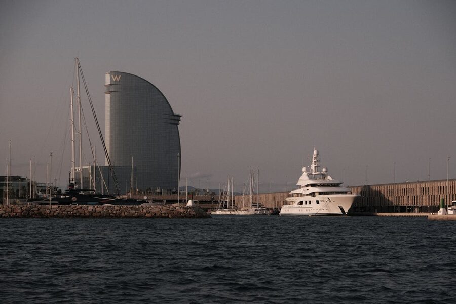 Scenic sunset at Port Vell Barcelona with W Hotel and luxury yachts