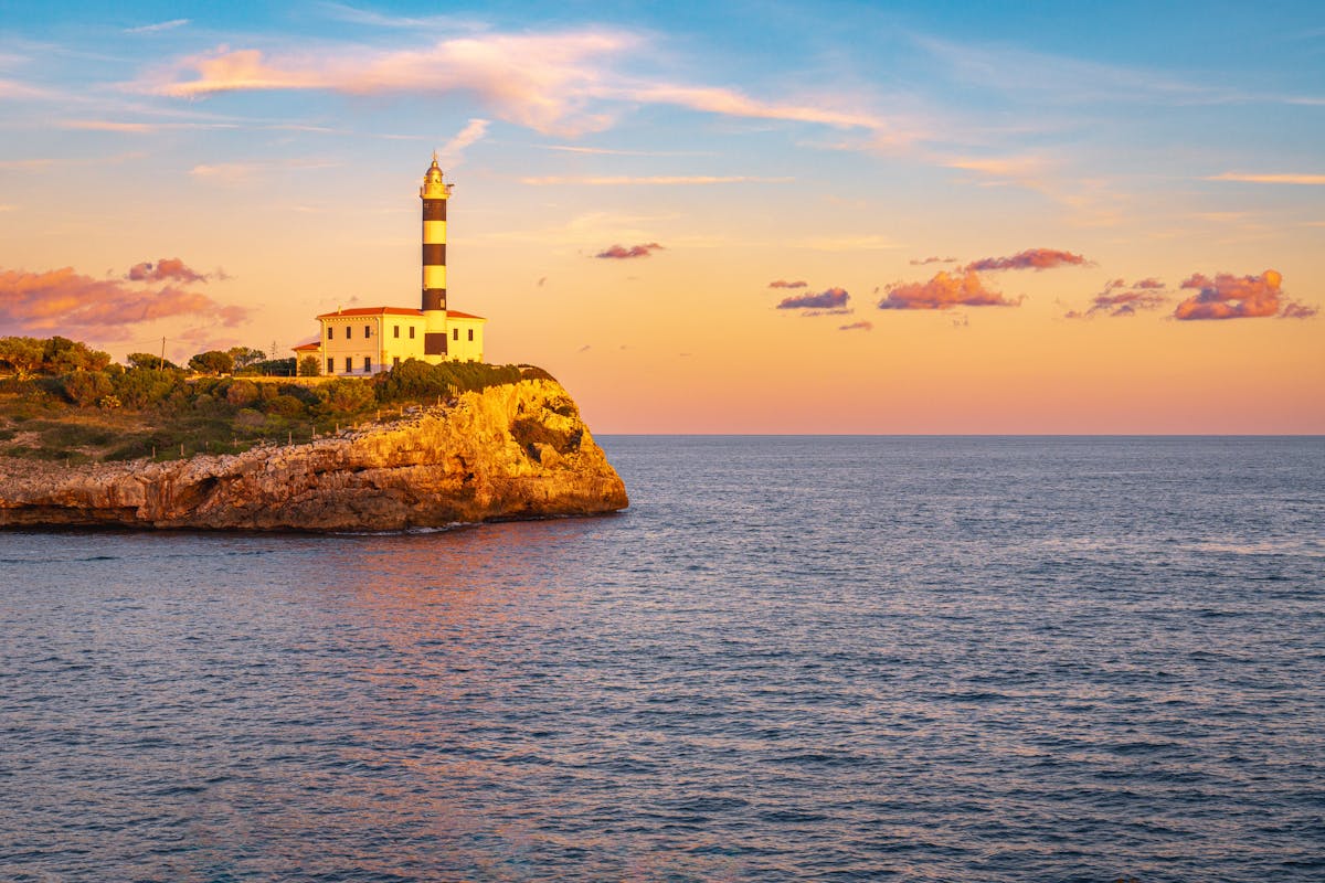 Beautiful sunset view of lighthouse on the coast of Portocolom Mallorca Spain