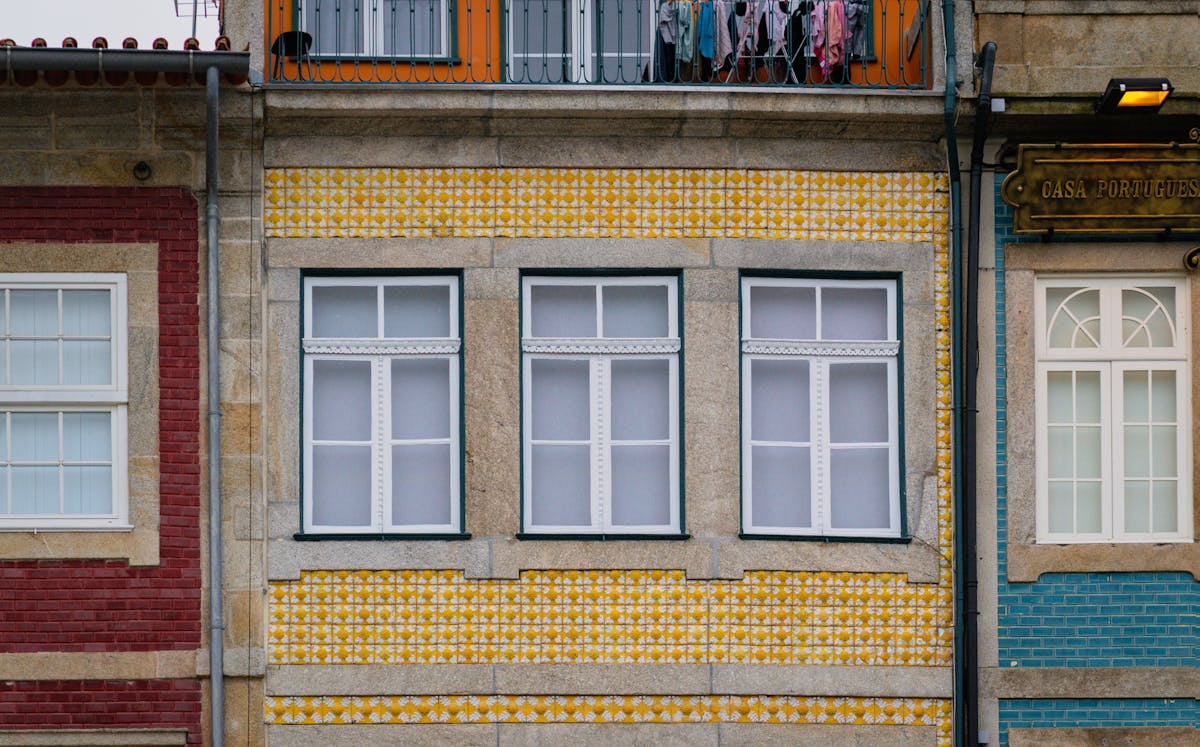 Building facade covered in traditional yellow Portuguese azulejo tiles in Porto