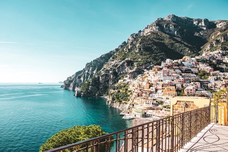 Colorful pastel buildings cascading down the cliffs of Positano toward the Mediterranean
