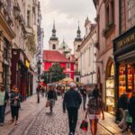 Charming cobblestone street in Prague Old Town with tourists and historic architecture