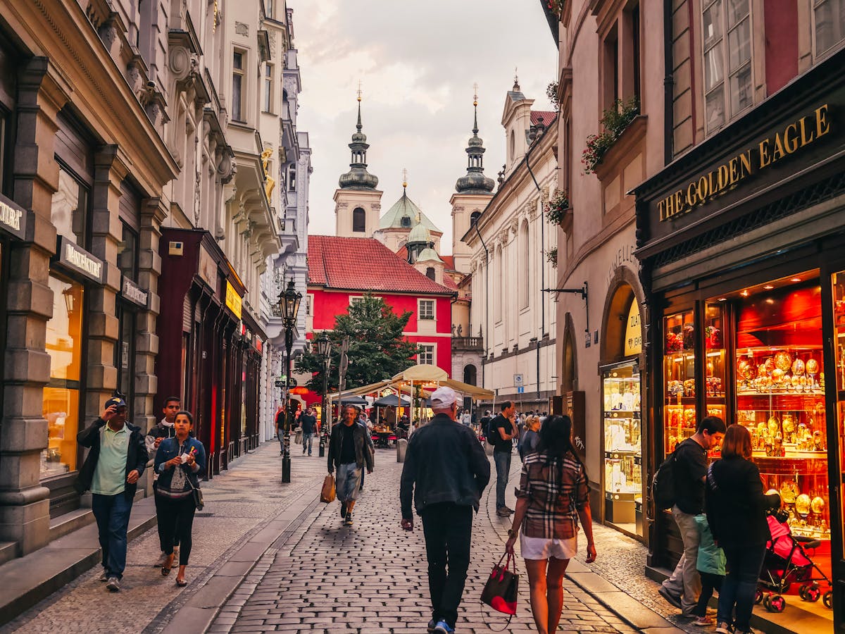 Charming cobblestone street in Prague Old Town with tourists and historic architecture