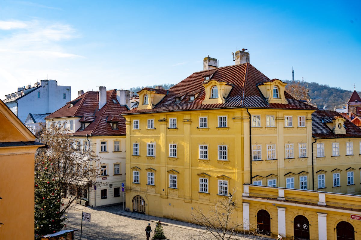 View of colorful historic buildings in Prague with a blue sky backdrop