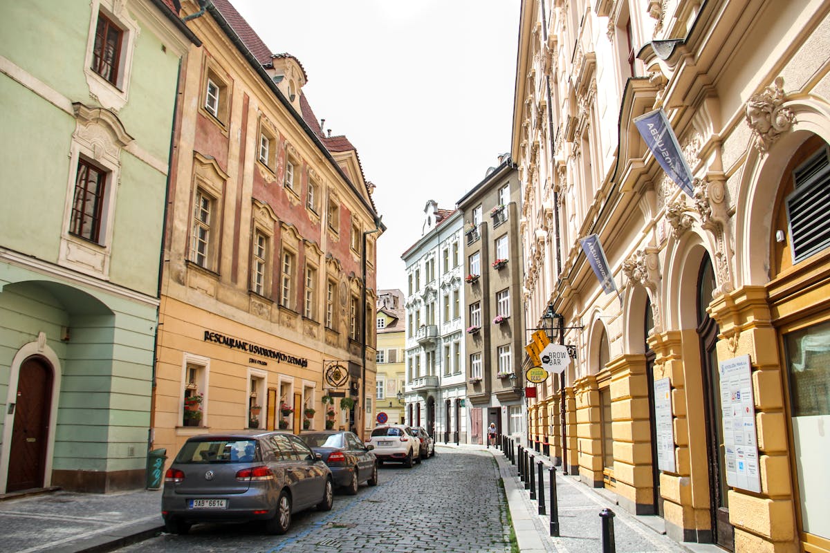 Cobblestone street in Prague Old Town lined with colorful historic buildings