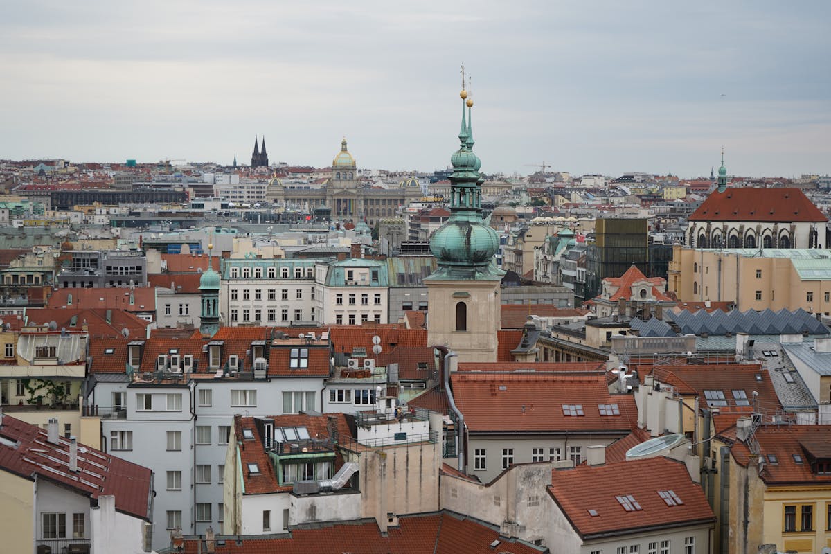 Scenic aerial view of Prague historic rooftops with red tiles and landmarks