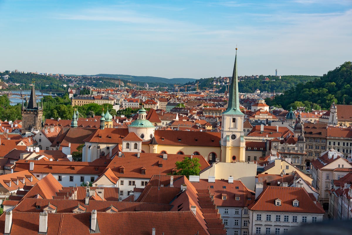 Aerial view of Prague red rooftops with Prague Castle and landmarks visible