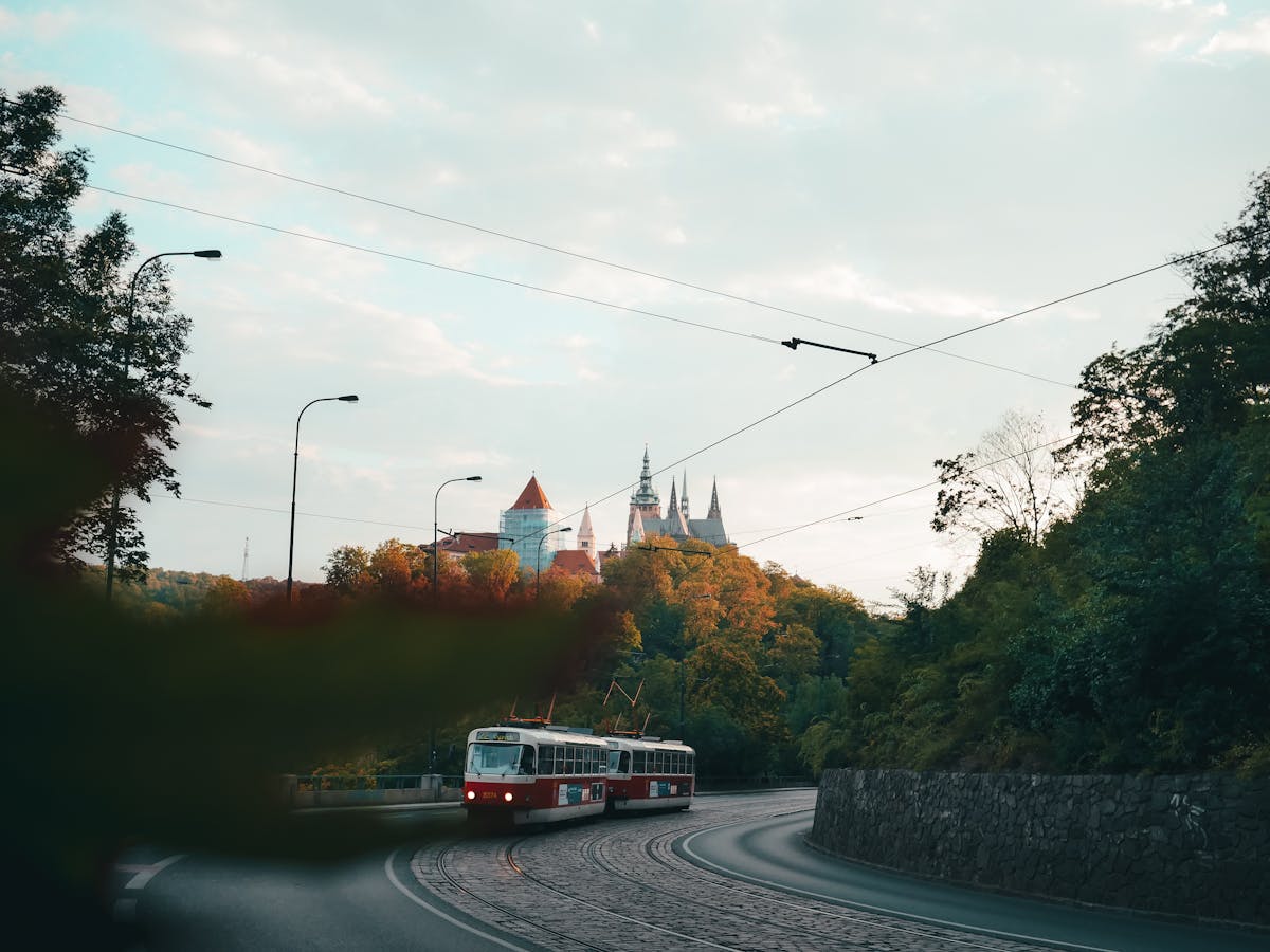 A vintage Prague tram with Prague Castle visible in the background