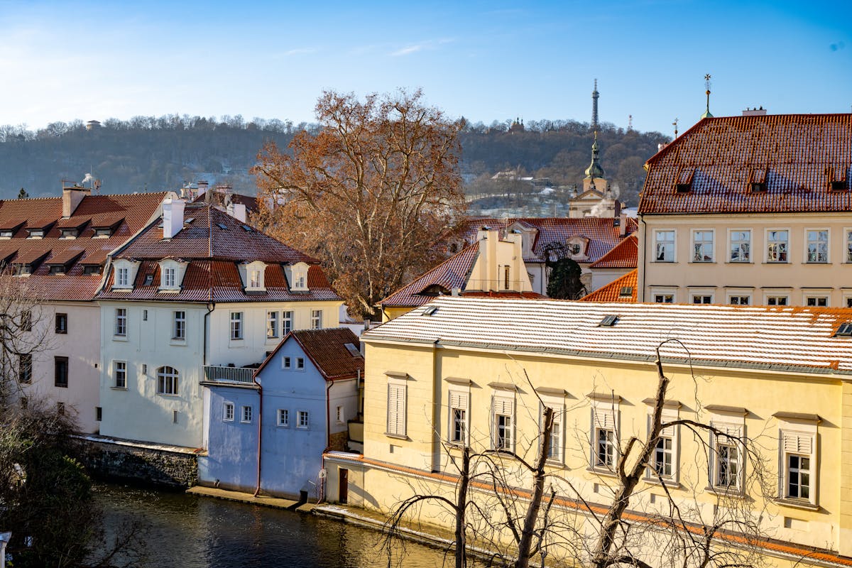 Picturesque winter view of historic Prague buildings with snowy rooftops