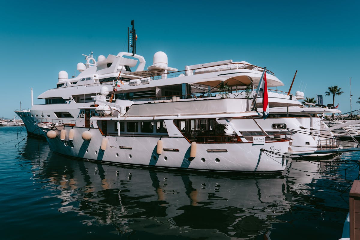 Yachts docked at Puerto Banus marina under clear blue sky