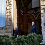 Guards standing by statues at the entrance of Palazzo Vecchio in Florence
