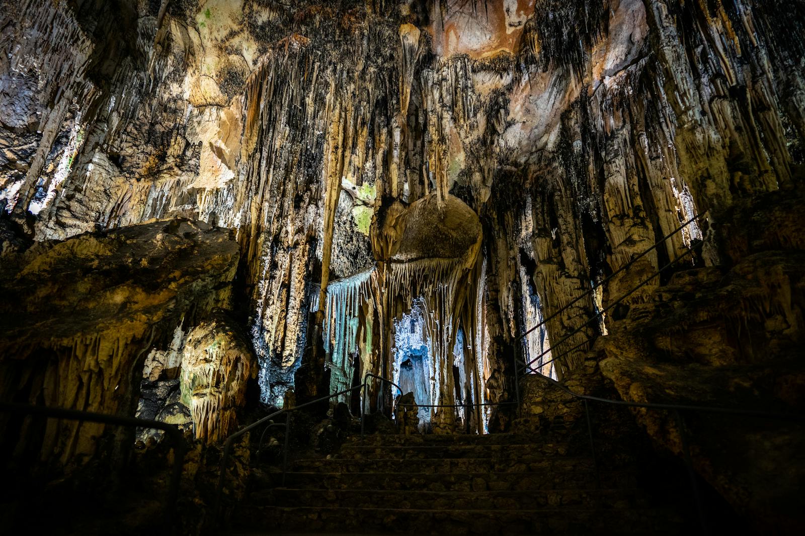 Stalactite formations illuminated inside a Spanish cave chamber