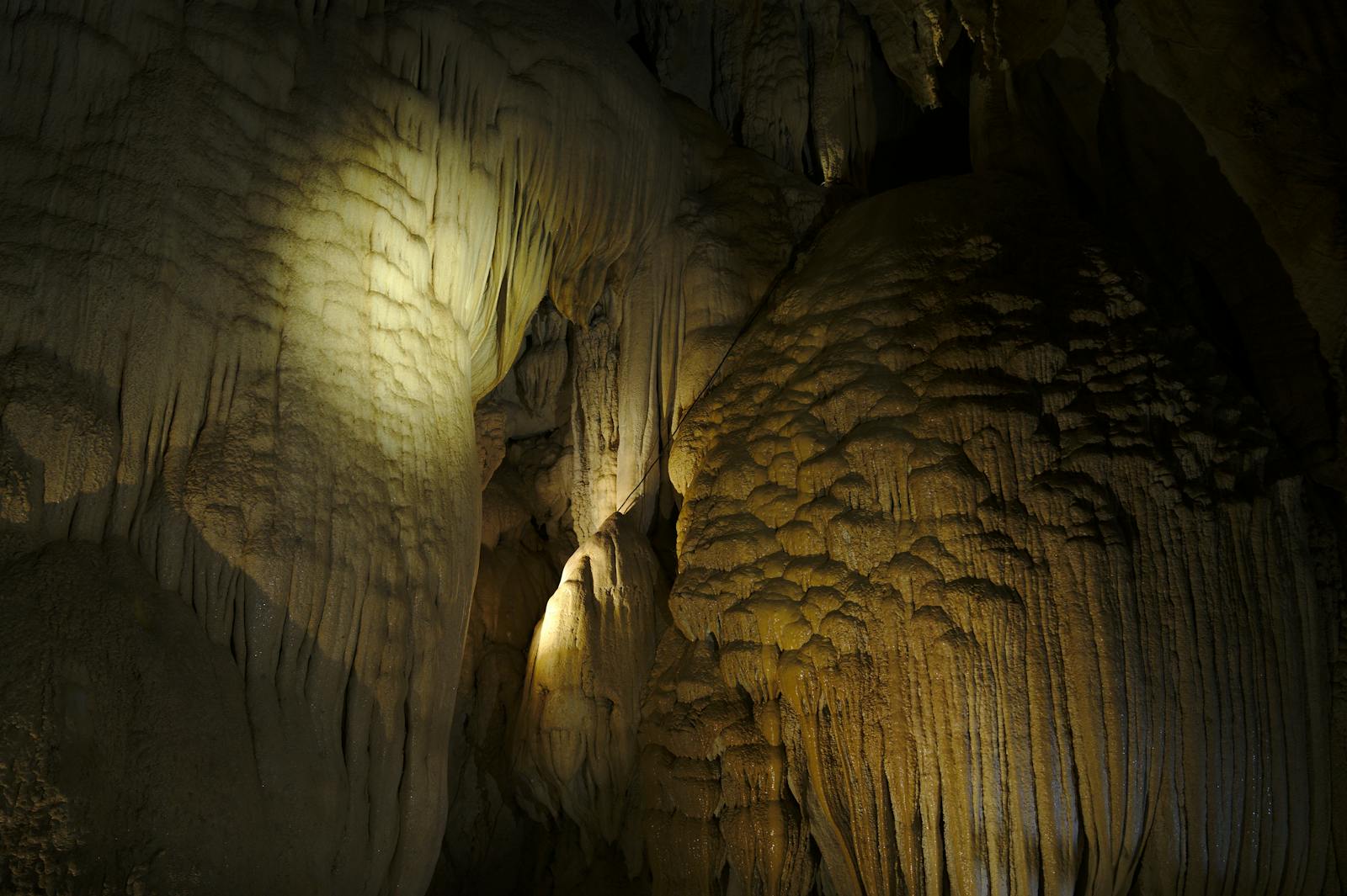 Stalactites and cave formations lit with natural lighting