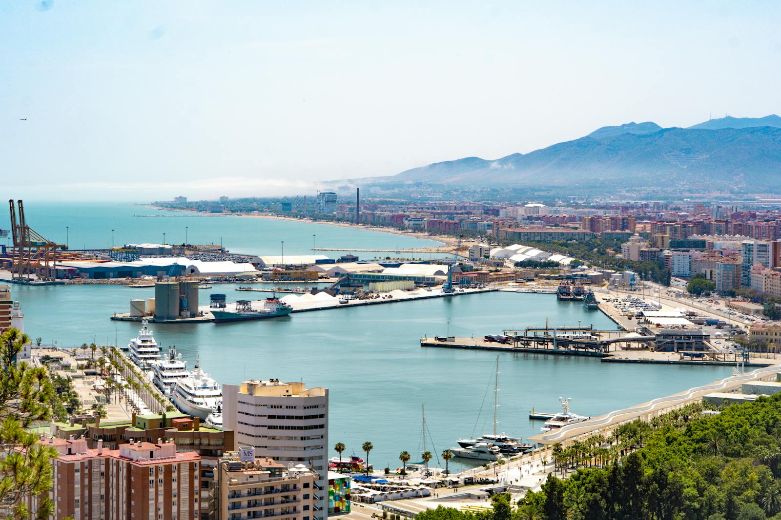Aerial view of Malaga port and cityscape with mountainous backdrop