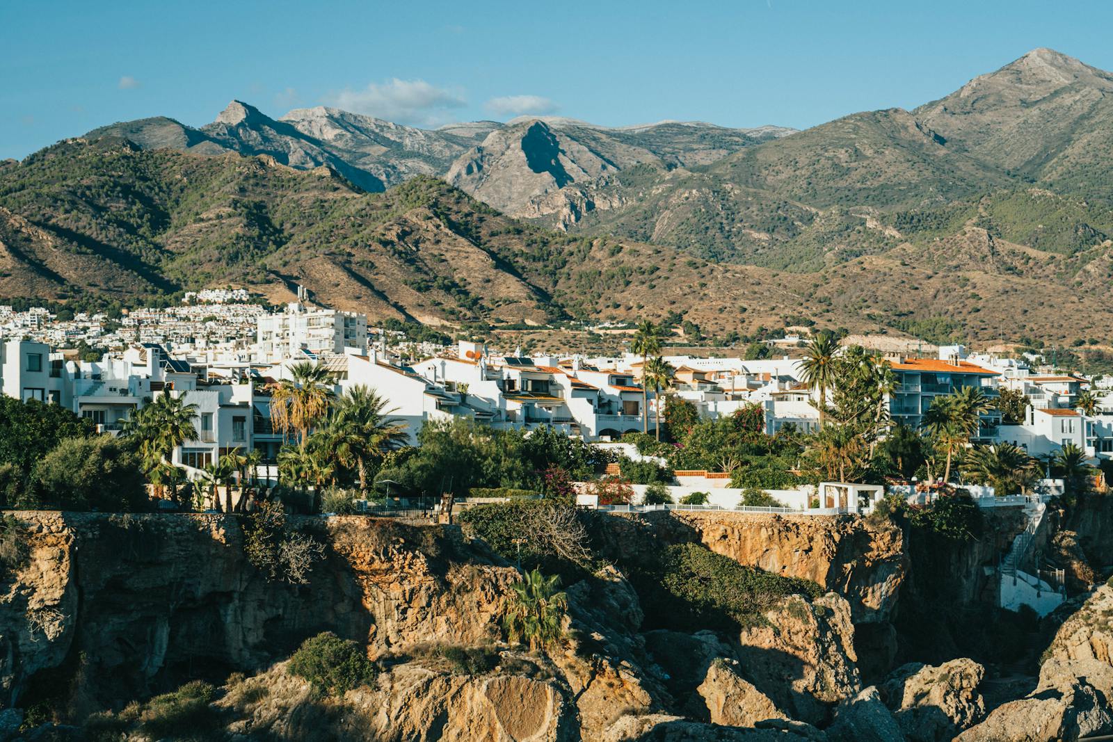White buildings of Nerja town with mountain backdrop in Andalusia