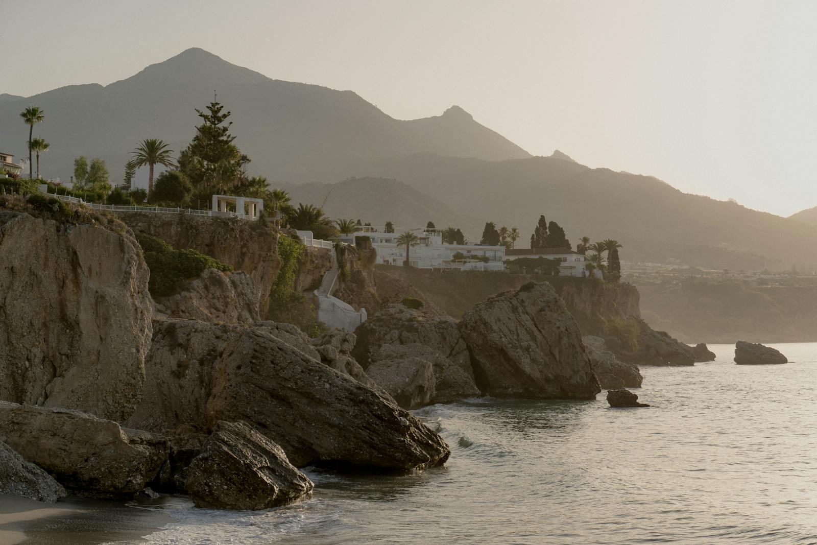Dramatic coastal cliffs bathed in sunrise light along the Mediterranean coast near Nerja