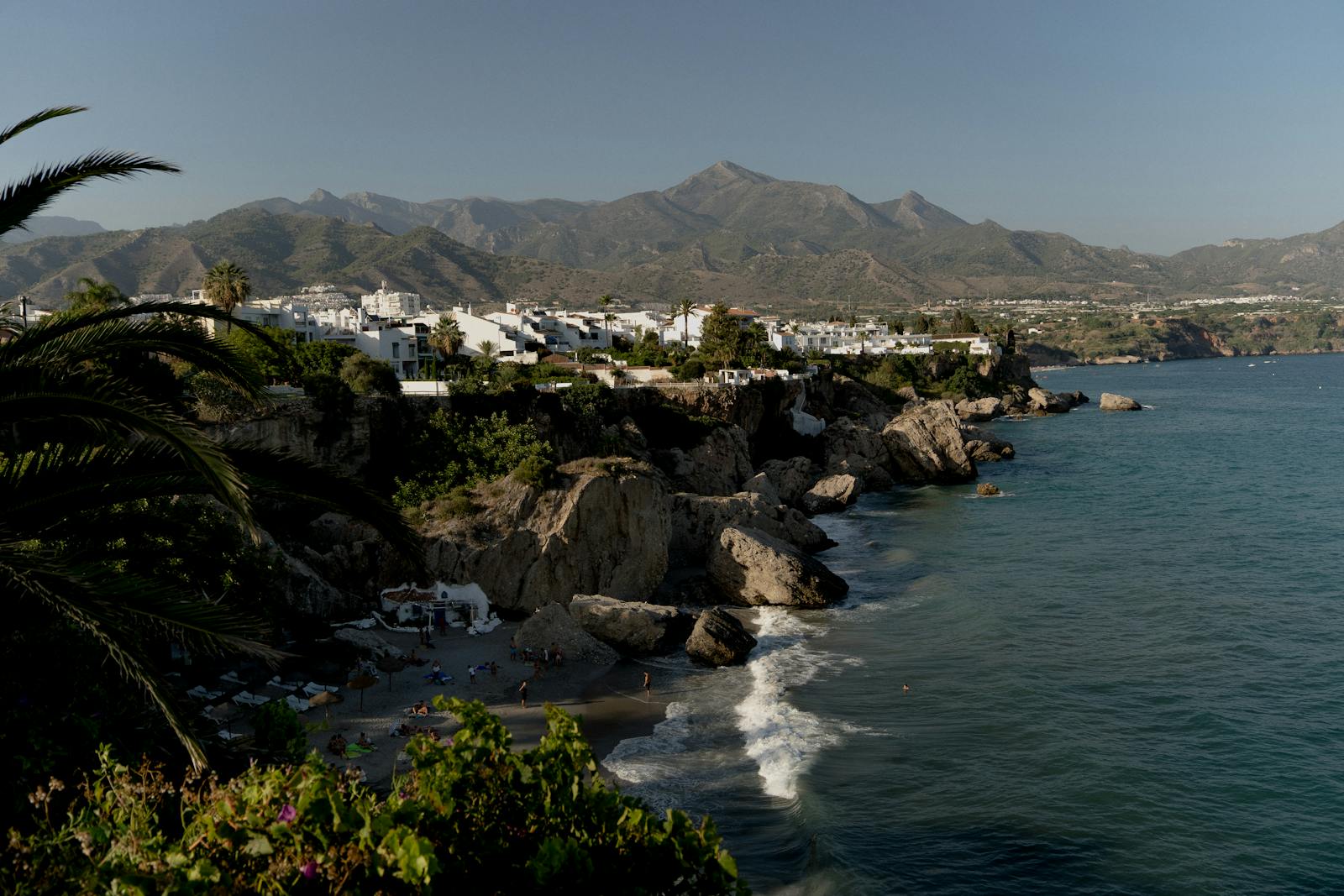 Rocky coastline near Nerja with mountains and clear blue sea