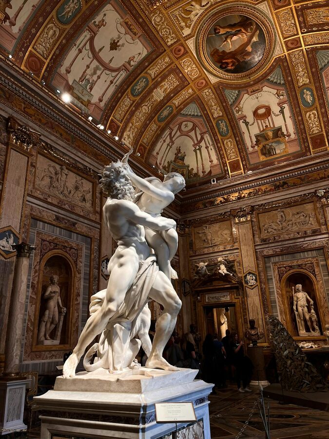 The Rape of Proserpina sculpture inside the Galleria Borghese showing mythological drama in marble