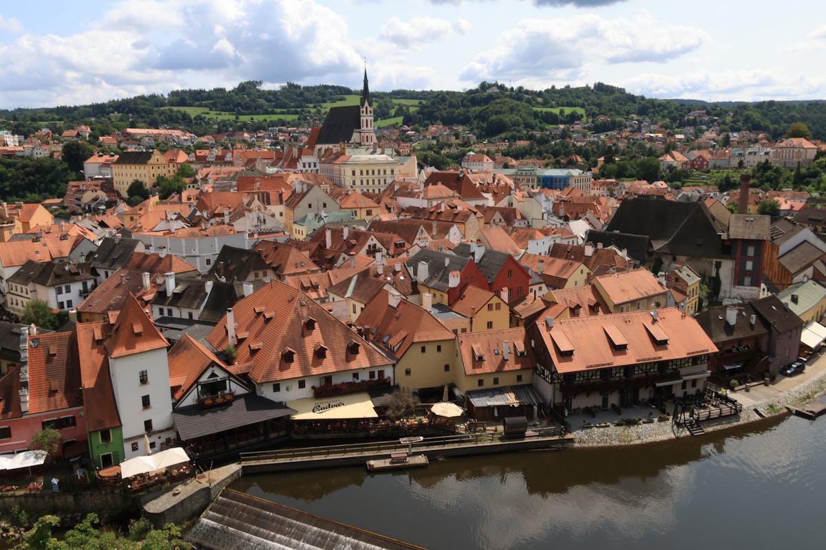 Aerial view of red-roofed buildings along the Vltava River in Cesky Krumlov