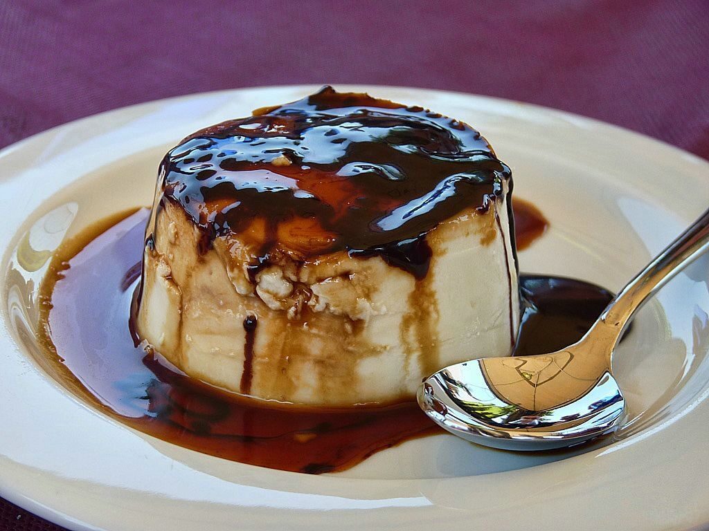 Close-up of Spanish flan dessert showing the smooth custard texture and liquid caramel topping