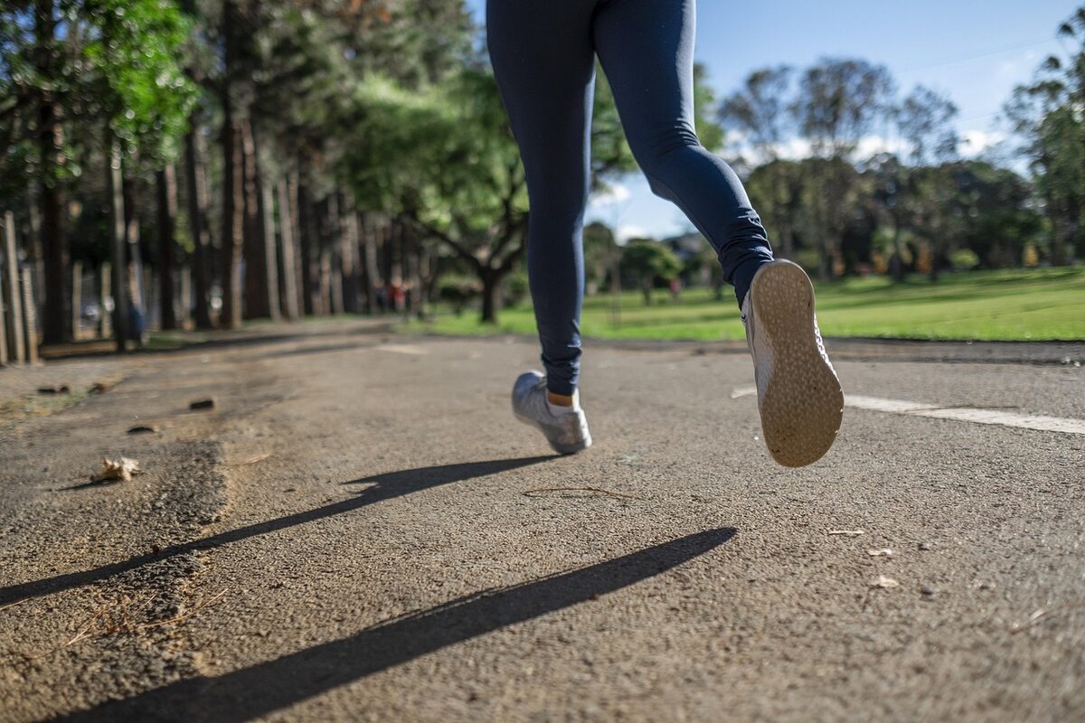 Woman running on a park fitness trail similar to Turia Gardens Valencia