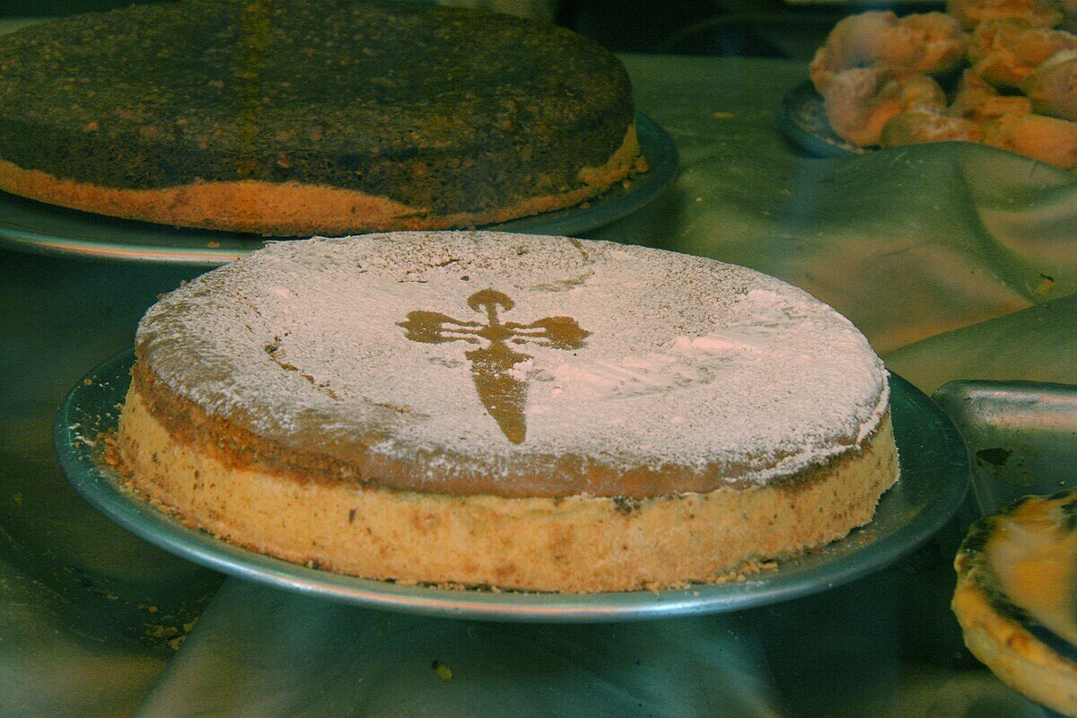 Traditional Galician almond cake tarta de Santiago decorated with the cross of Saint James in powdered sugar
