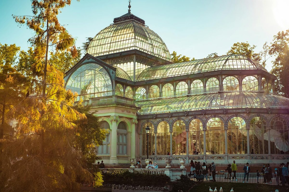 Palacio de Cristal reflected in pond at Retiro Park Madrid