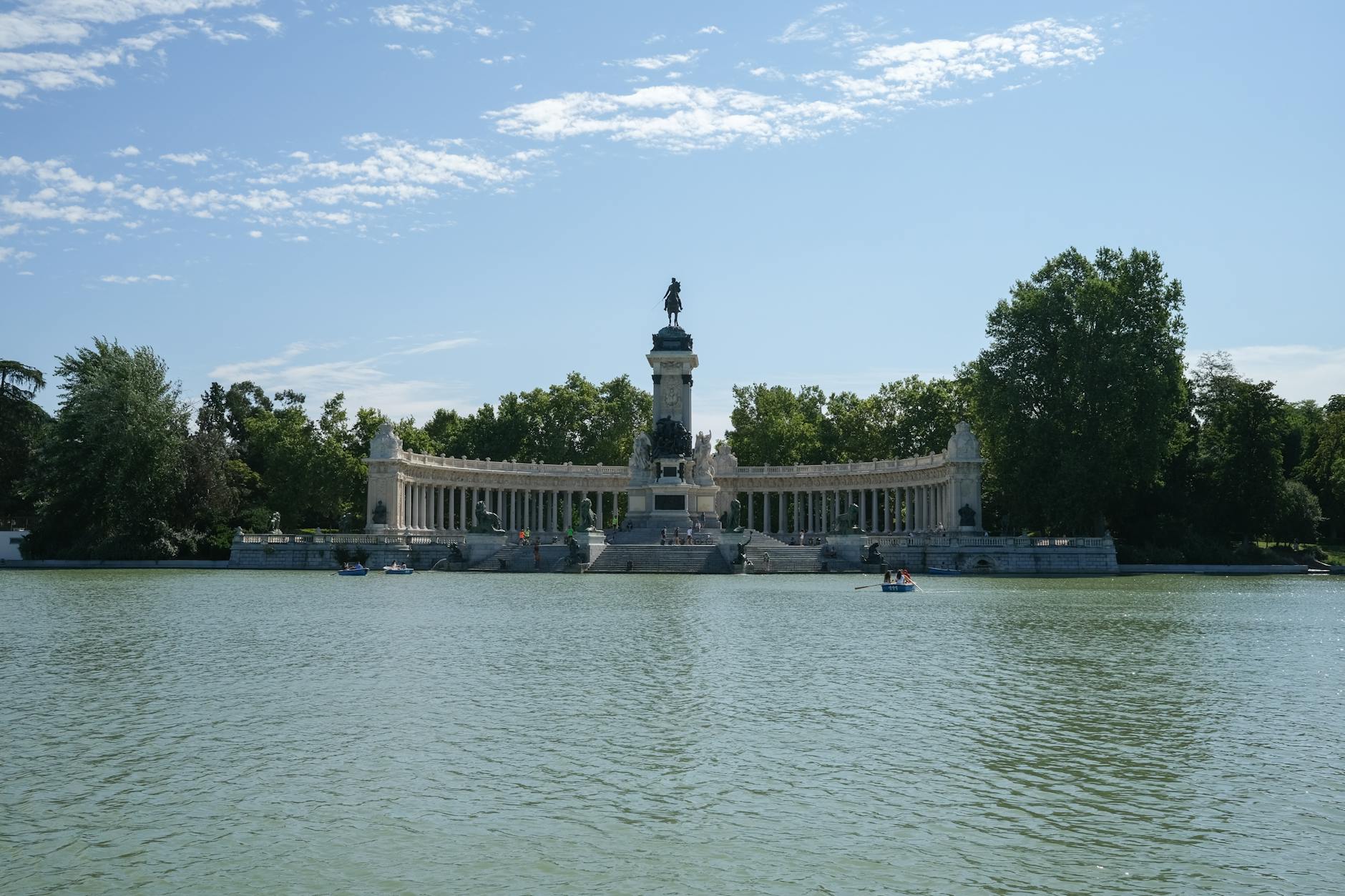 Scenic view of the Alfonso XII monument reflected in the pond at El Retiro Park, Madrid