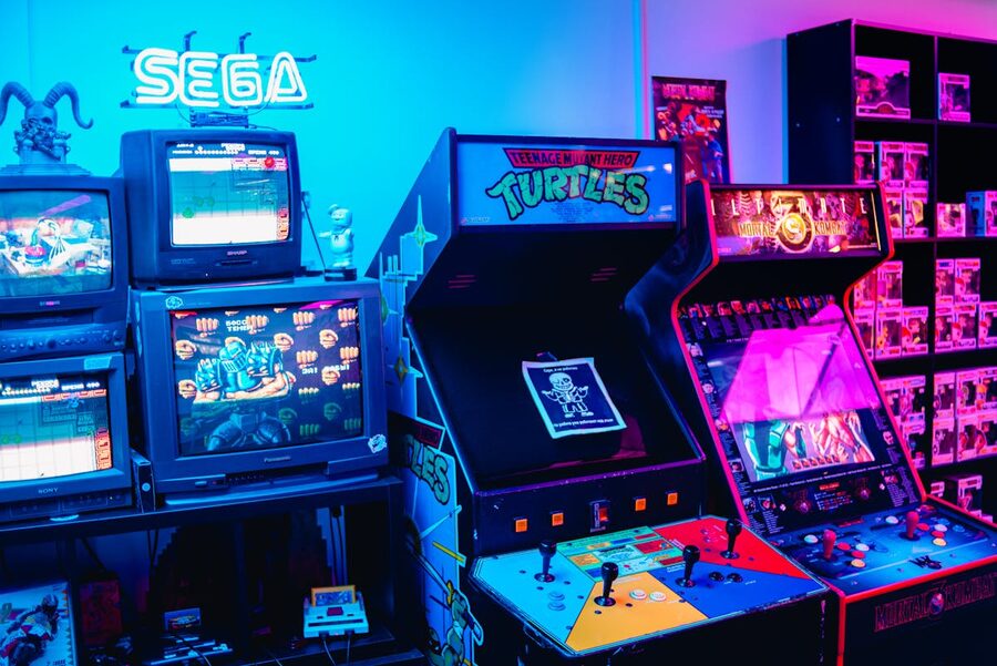 Classic retro arcade room featuring classic gaming machines and colorful neon lights