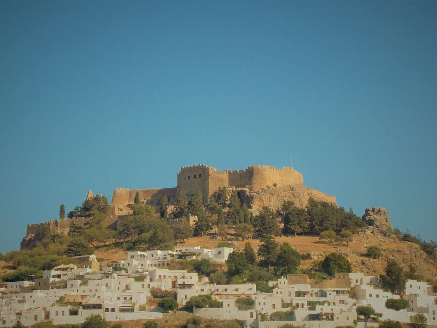Lindos Acropolis on a hill with a clear blue sky