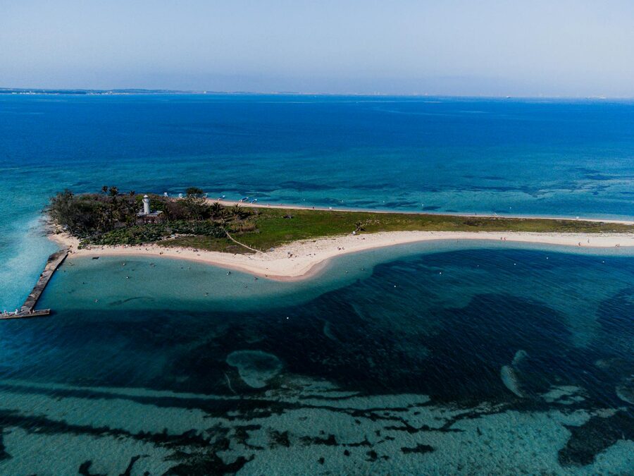Aerial view of an island surrounded by turquoise water