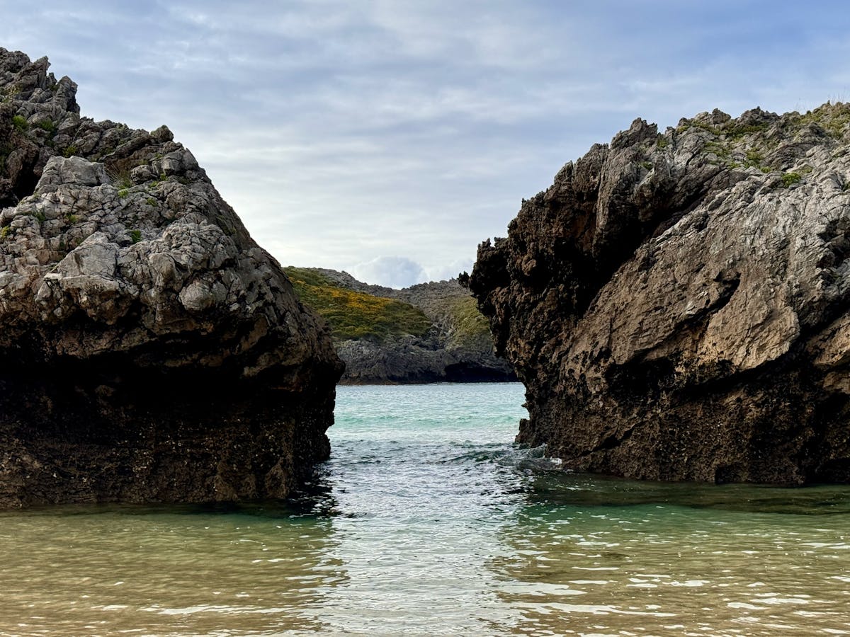 View through a rocky coastal passage to the sea in Spain