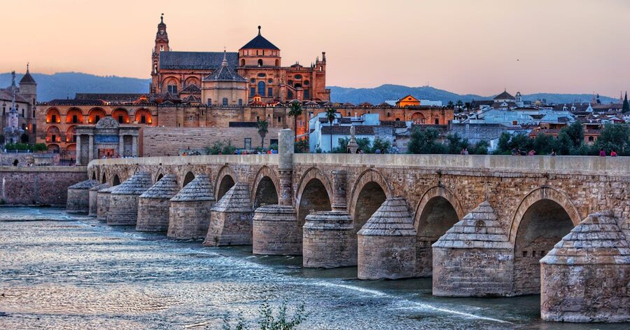 Evening view of the Roman Bridge with the Mosque-Cathedral behind in Cordoba