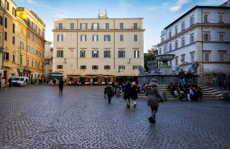 A Roman piazza with cobblestone streets and historic buildings