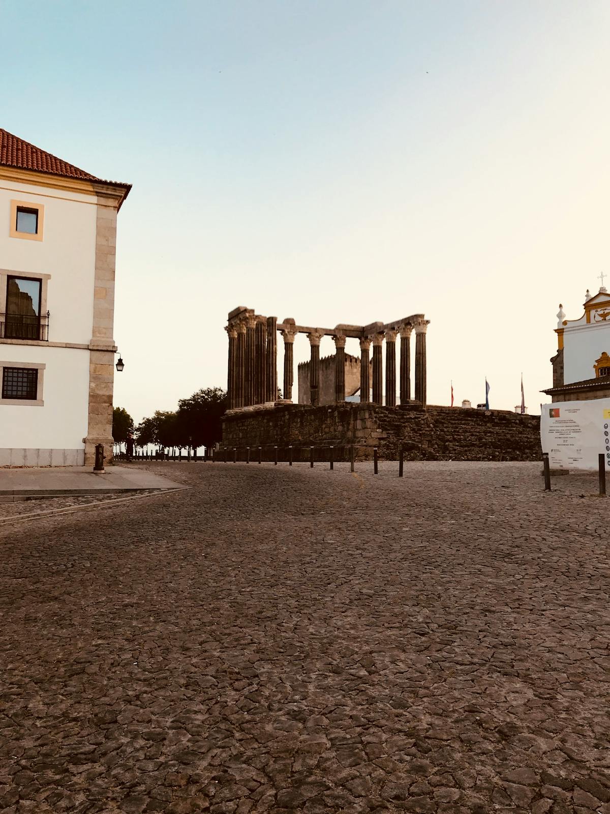 The Roman Temple of Évora with Corinthian columns standing in afternoon sunlight