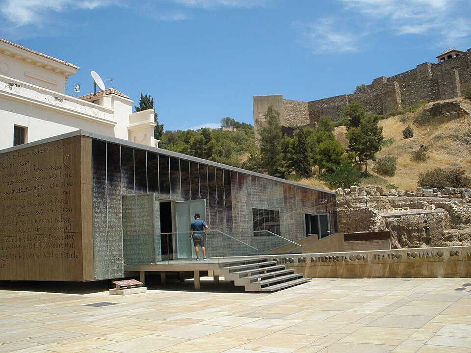 Roman Theatre ruins with the Alcazaba fortress rising behind them in Malaga