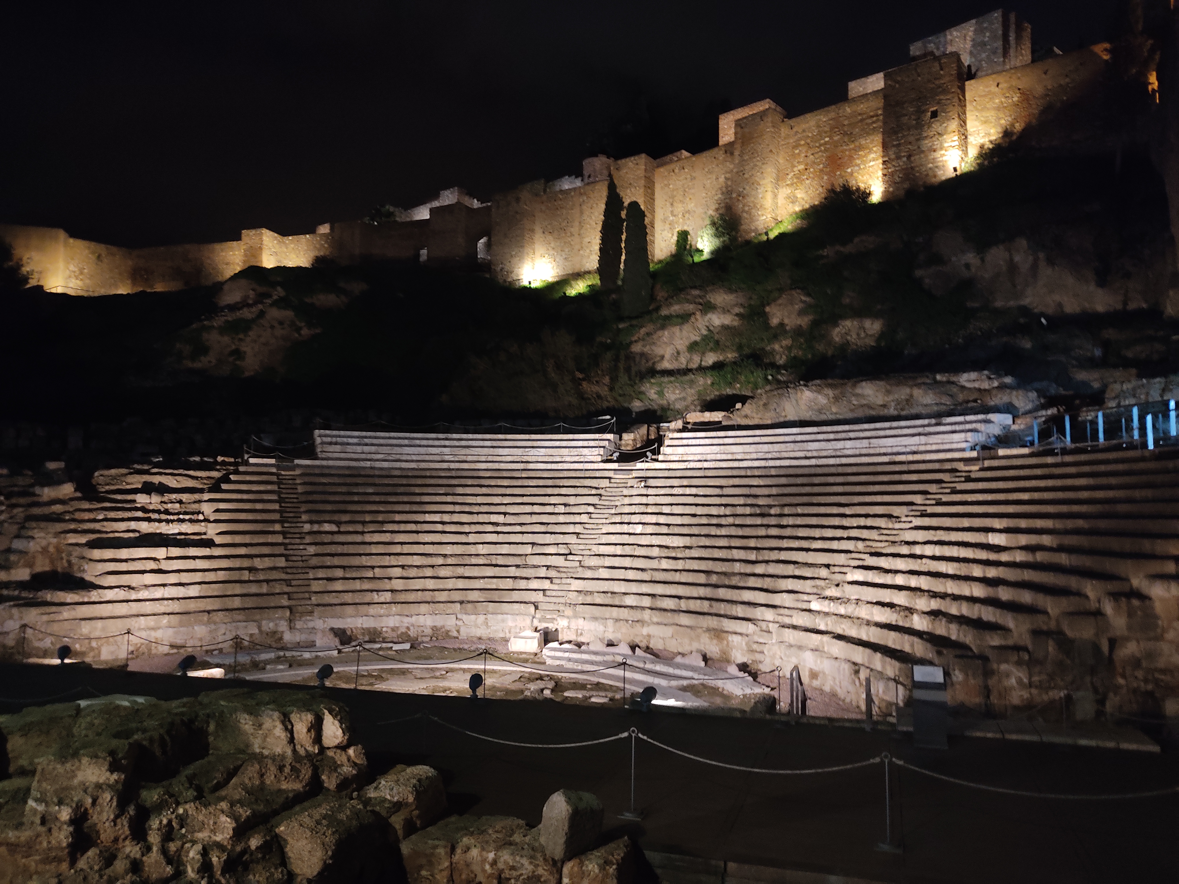 Ancient Roman Theatre ruins in Malaga Spain with Alcazaba fortress above