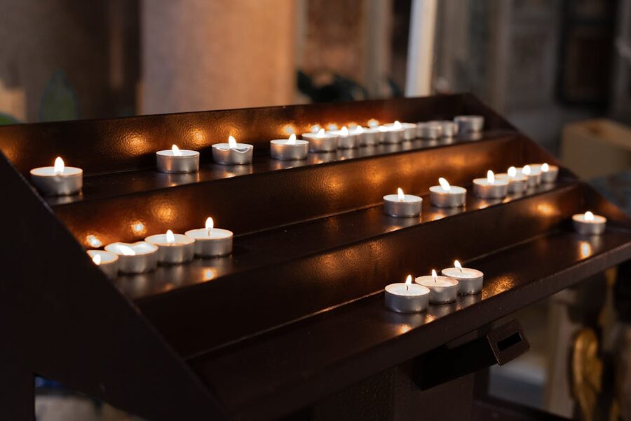 Candles and warm light inside a historic church in Rome creating an atmospheric setting