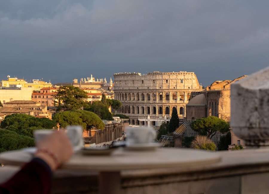 Scenic view of the Colosseum from a cafe terrace at sunset in Rome