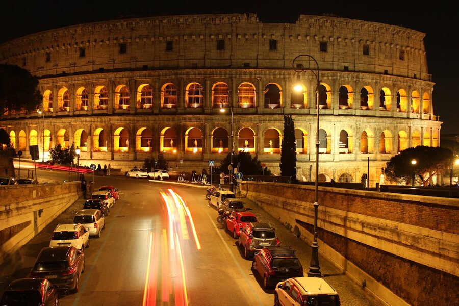 The Colosseum illuminated at night in Rome with dramatic lighting