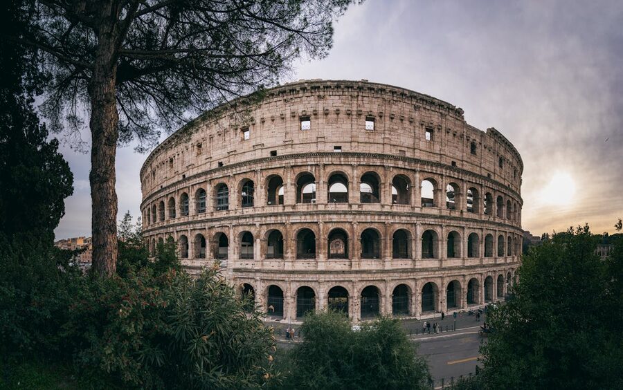Wide angle shot of the Colosseum in Rome with a sunset backdrop